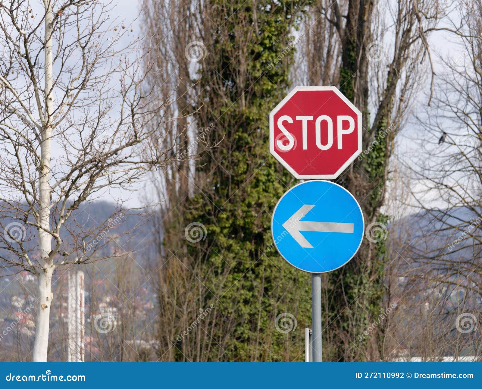 Red Stop Sign and a Turn Left Sign on the Road Stock Photo - Image of ...