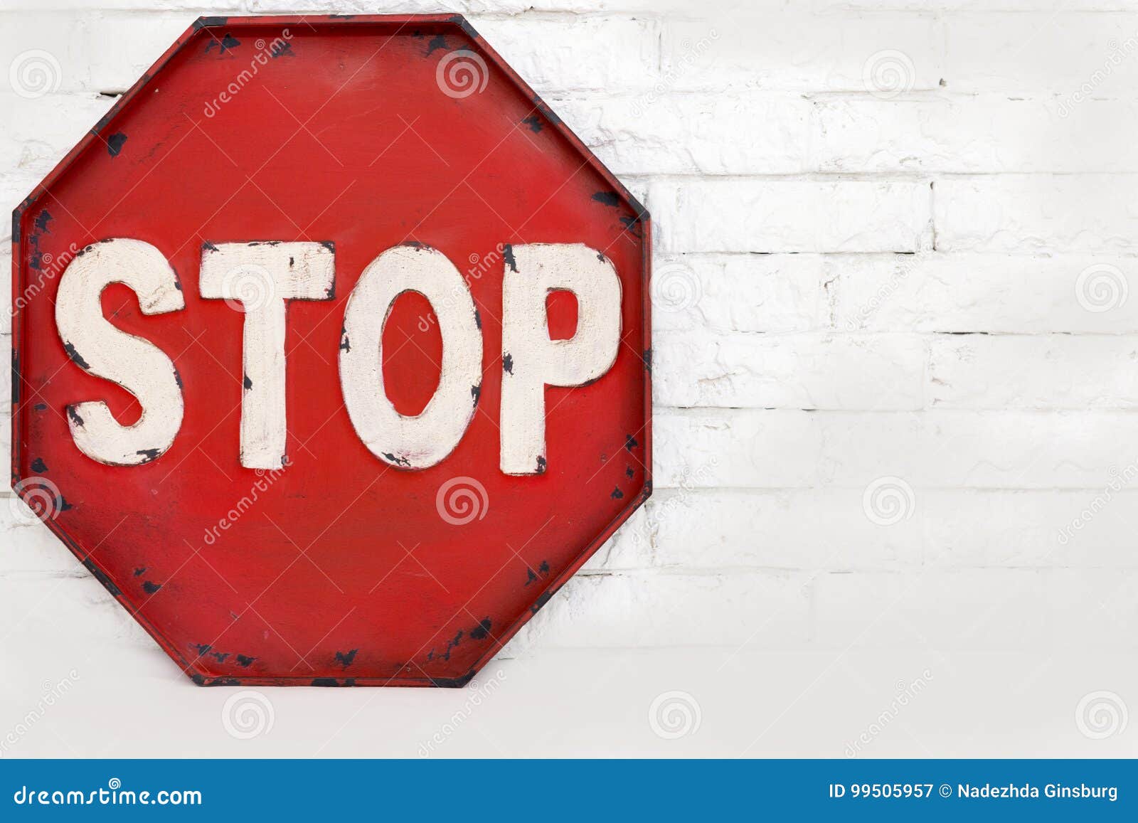 Red Stop Symbol on a White Brick Wall, Object. Stock Image - Image of ...