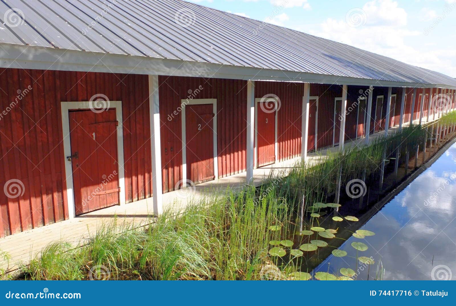 Red Storage Building by a Lake Stock Photo - Image of river, color ...
