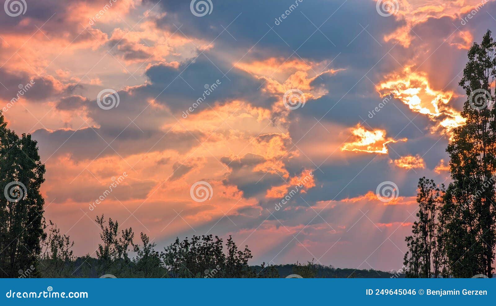 Red Sun Rays in the Cloudy Sky and Glowing Clouds at the Sunset Stock ...