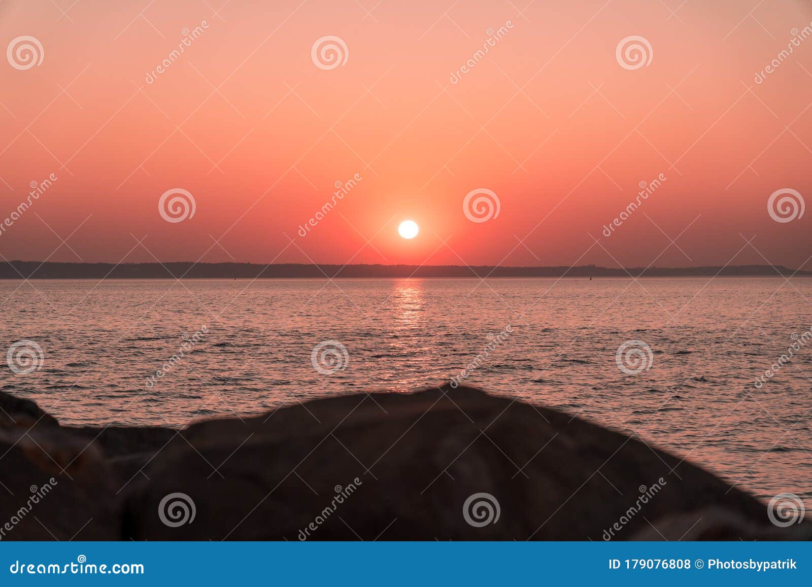 Red Sunset Over the Sea with Blurred Rocky Foreground, Spring Scene ...