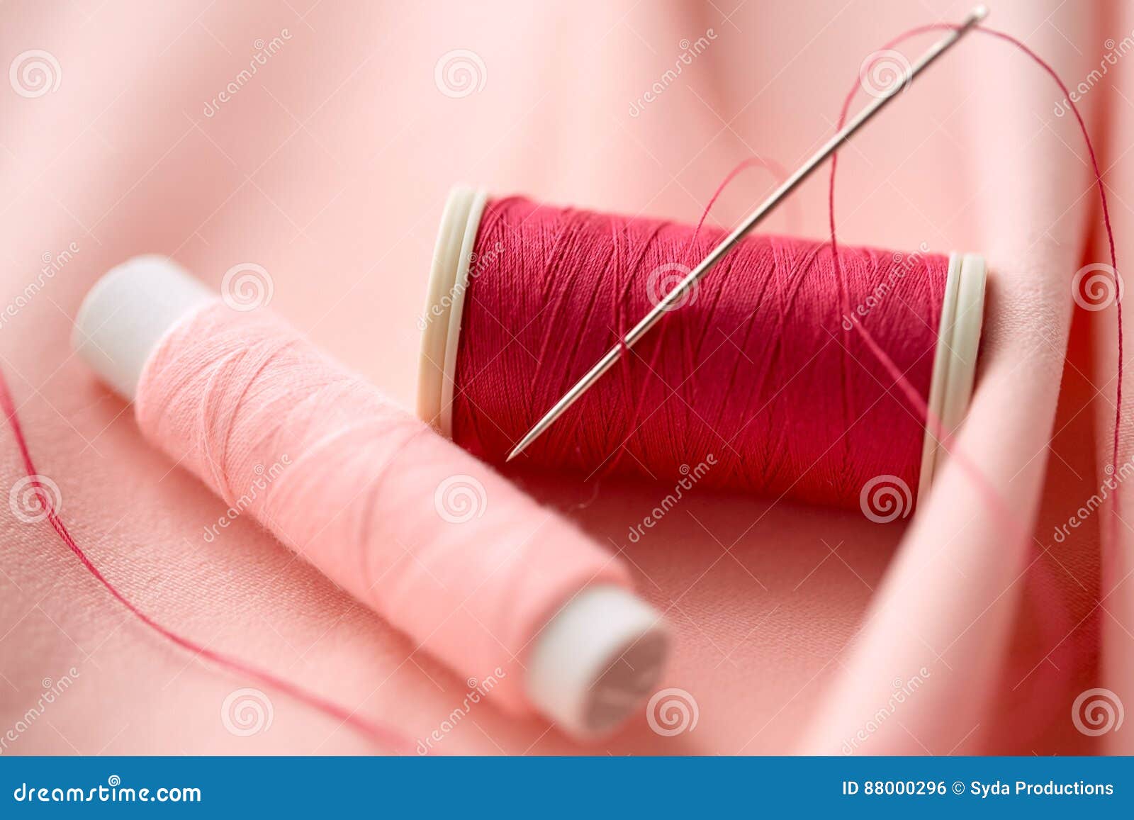 Red thread spool on cloth stock photo. Image of craft - 88000296