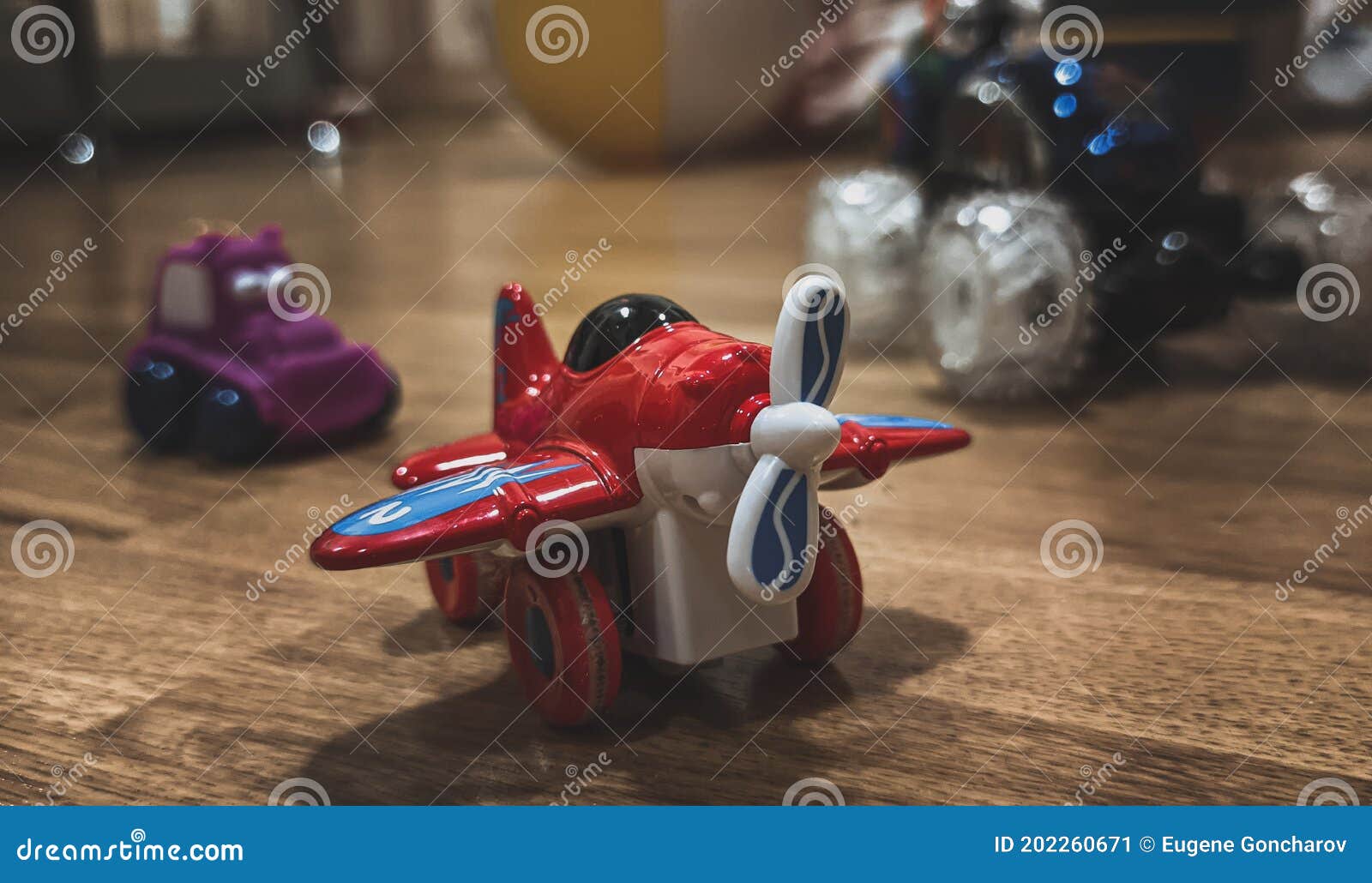 Red toy plane on the floor editorial photo. Image of floor - 202260671