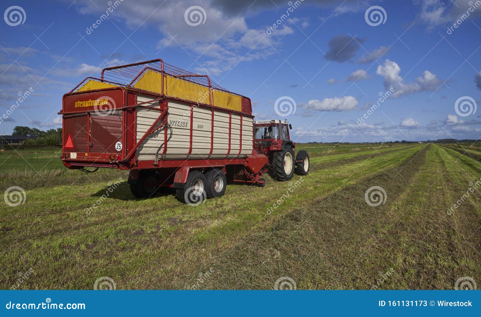 Red Tractor Driving on a Farm Field Under a Blue Sky at Daytime Stock ...