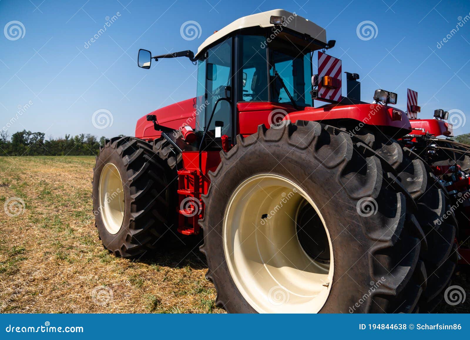 Red tractor on a field stock photo. Image of vehicle - 194844638