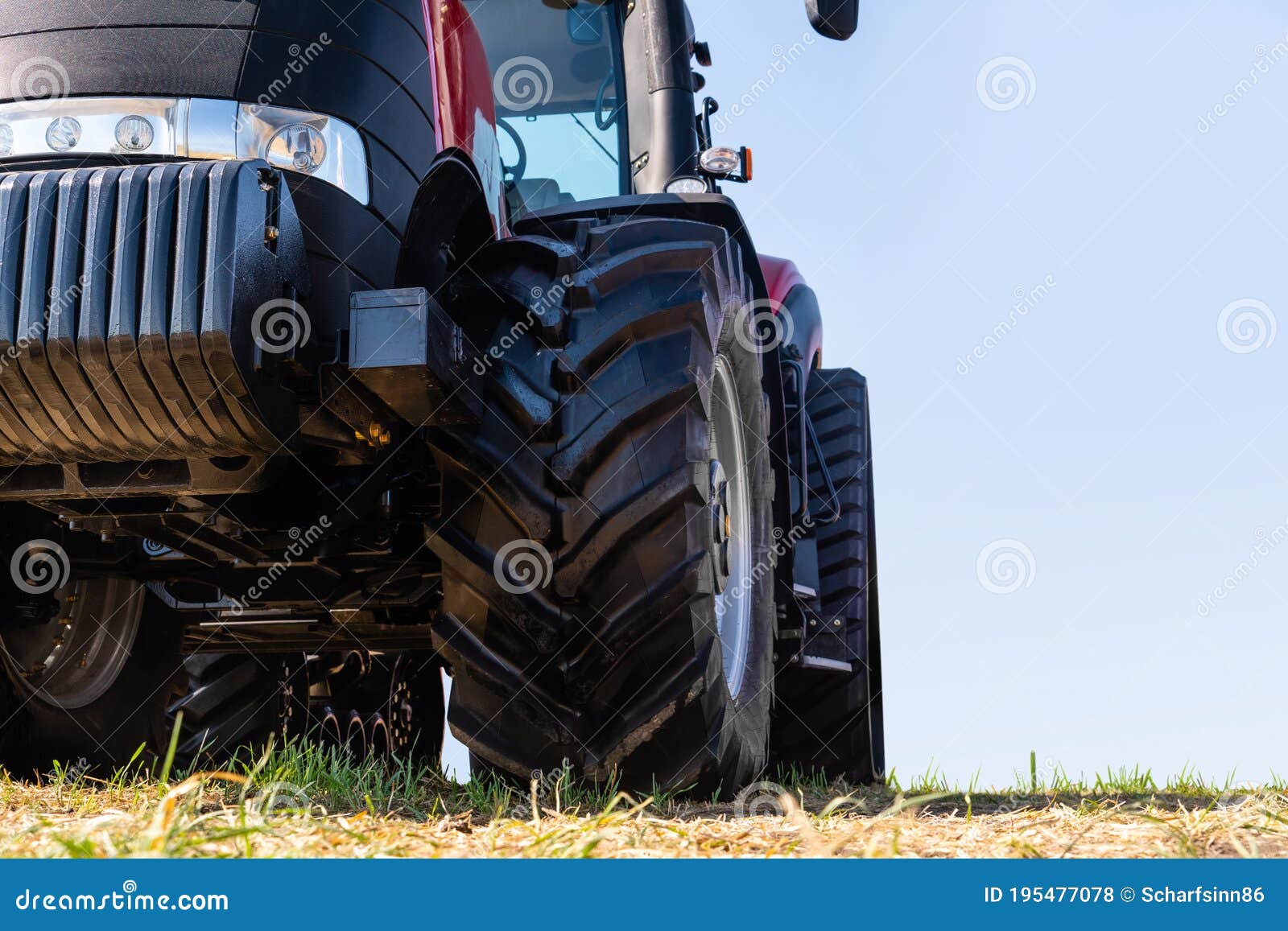Red tractor on a field stock photo. Image of tire, power - 195477078