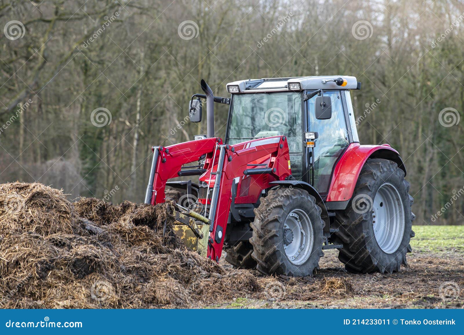 Red Tractor with Front Loader in Front of a Manure Heap Stock Image ...