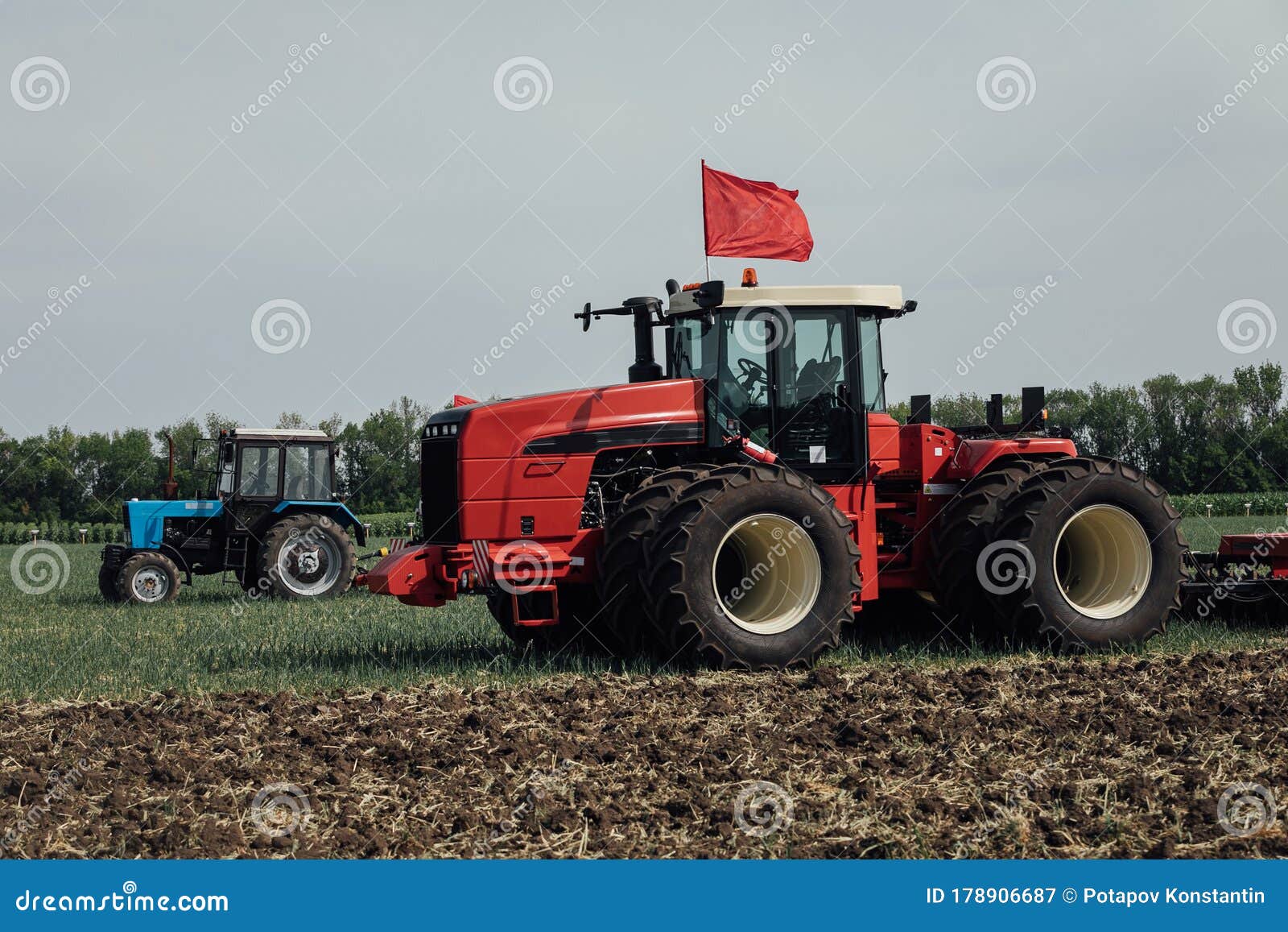 Red Tractor with Large Wheels in the Field during Tests during the ...