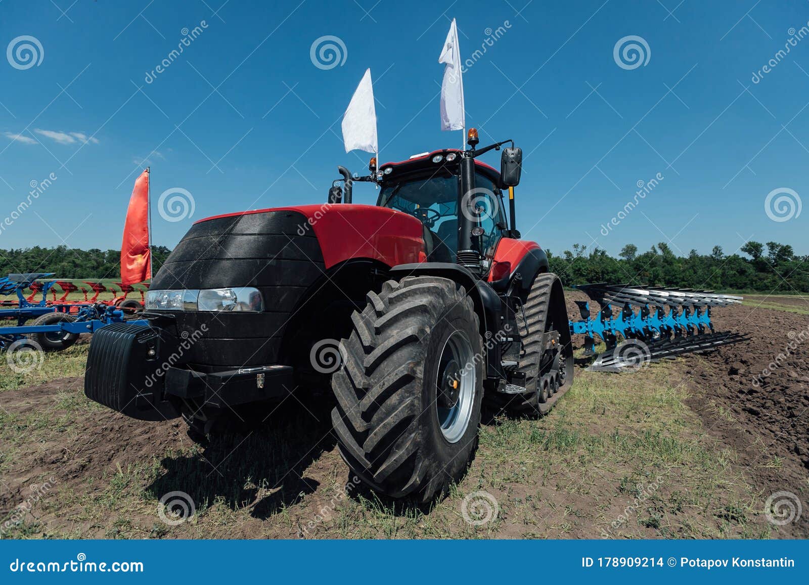 Red Tractor with Large Wheels in the Field during Tests during the ...