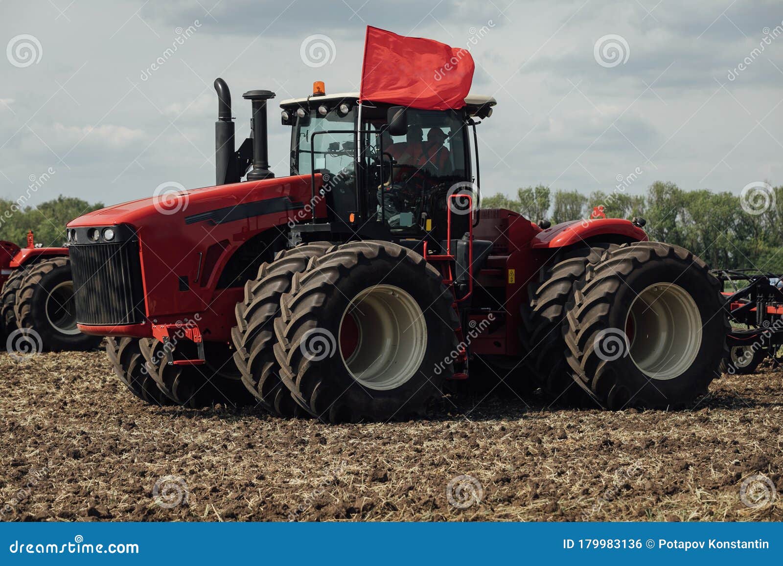 Red Tractor with Large Wheels in the Field during Tests during the ...