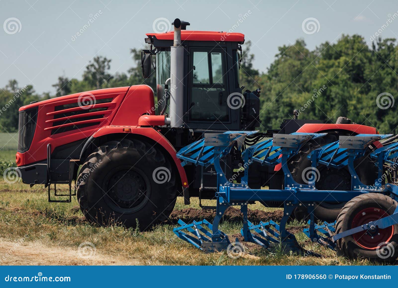 Red Tractor with Large Wheels in the Field during Tests during the ...