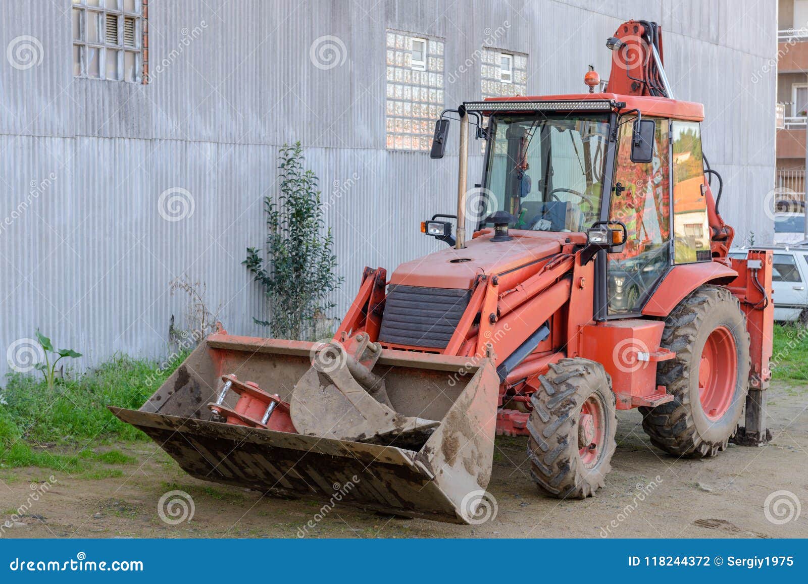 Red Tractor Parked Near a Gray Wall Stock Photo - Image of parked, gray ...