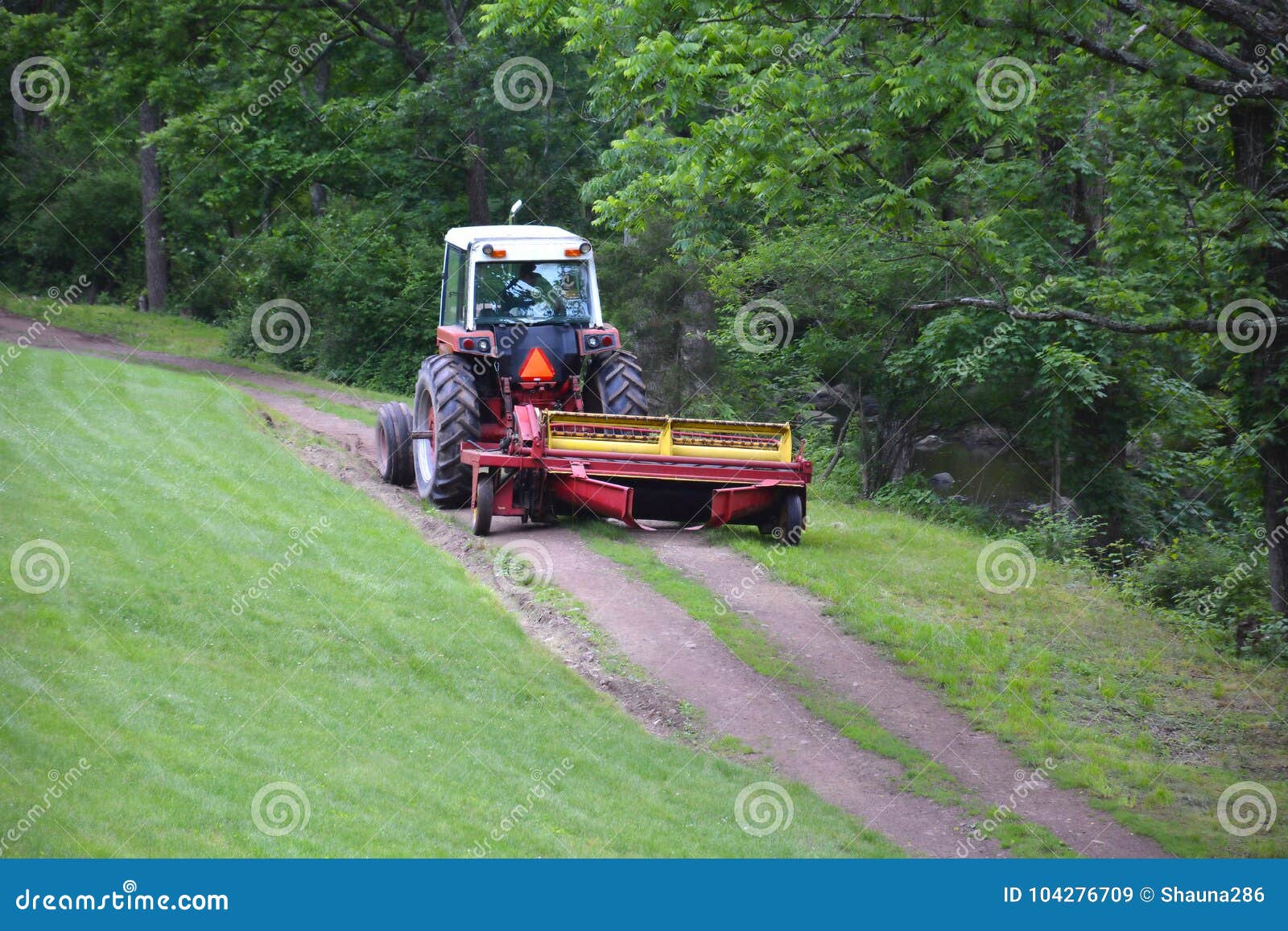 Red Tractor Pulling Disco Across Dirt Path Stock Image - Image of ...