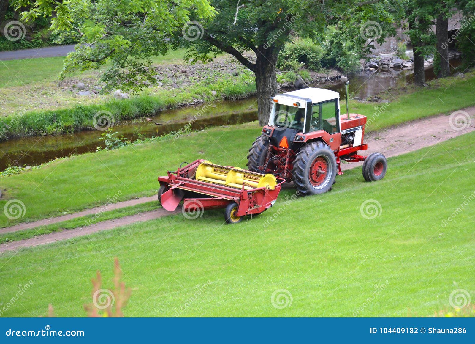 Red Tractor Pulling Disco Across Dirt Path Stock Photo - Image of ...