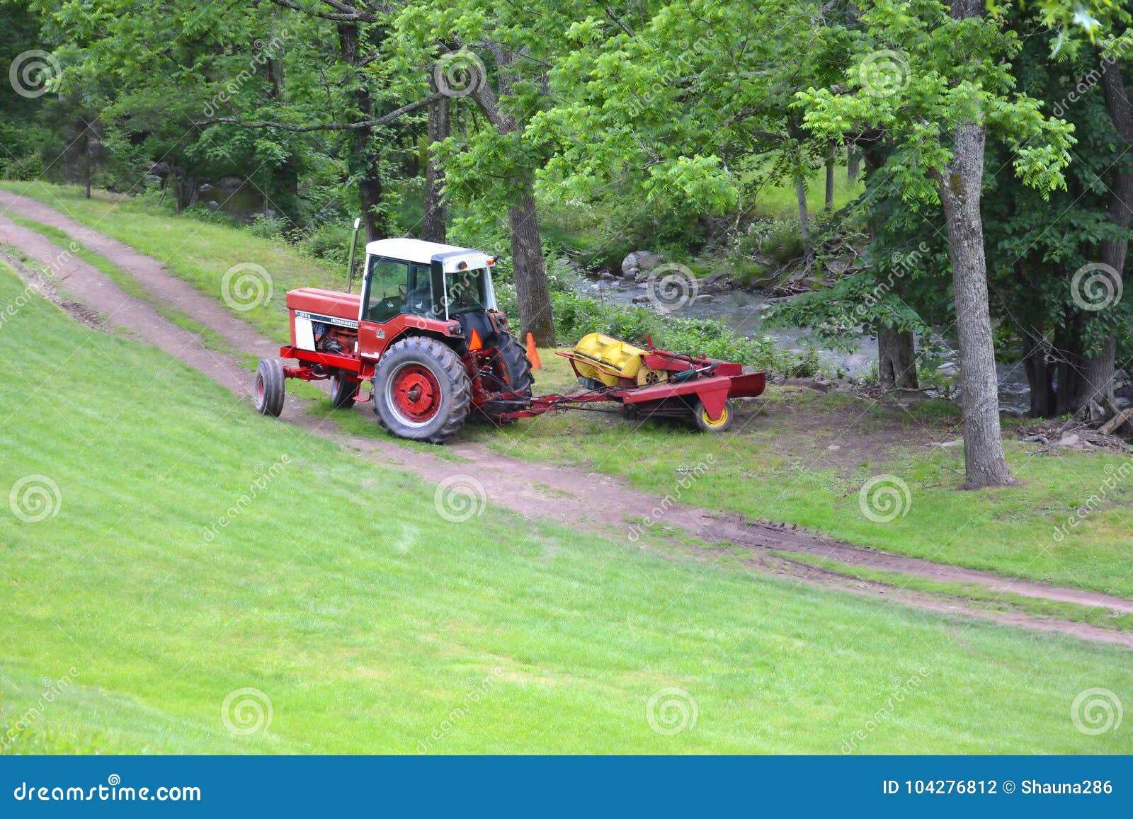 Red Tractor Pulling Disco Across Dirt Path Stock Photo - Image of green ...