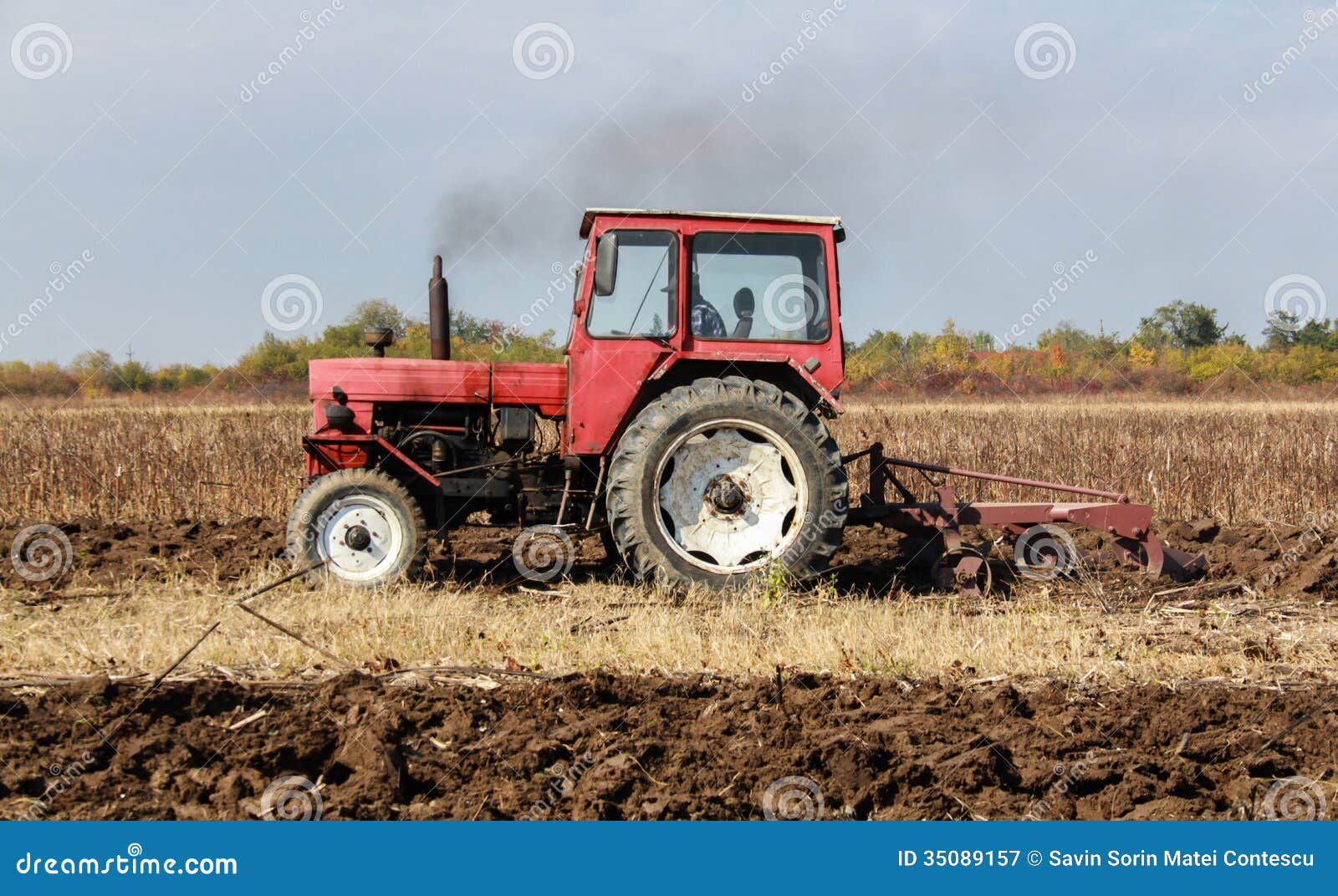 Red tractor at work stock image. Image of grass, brand - 35089157