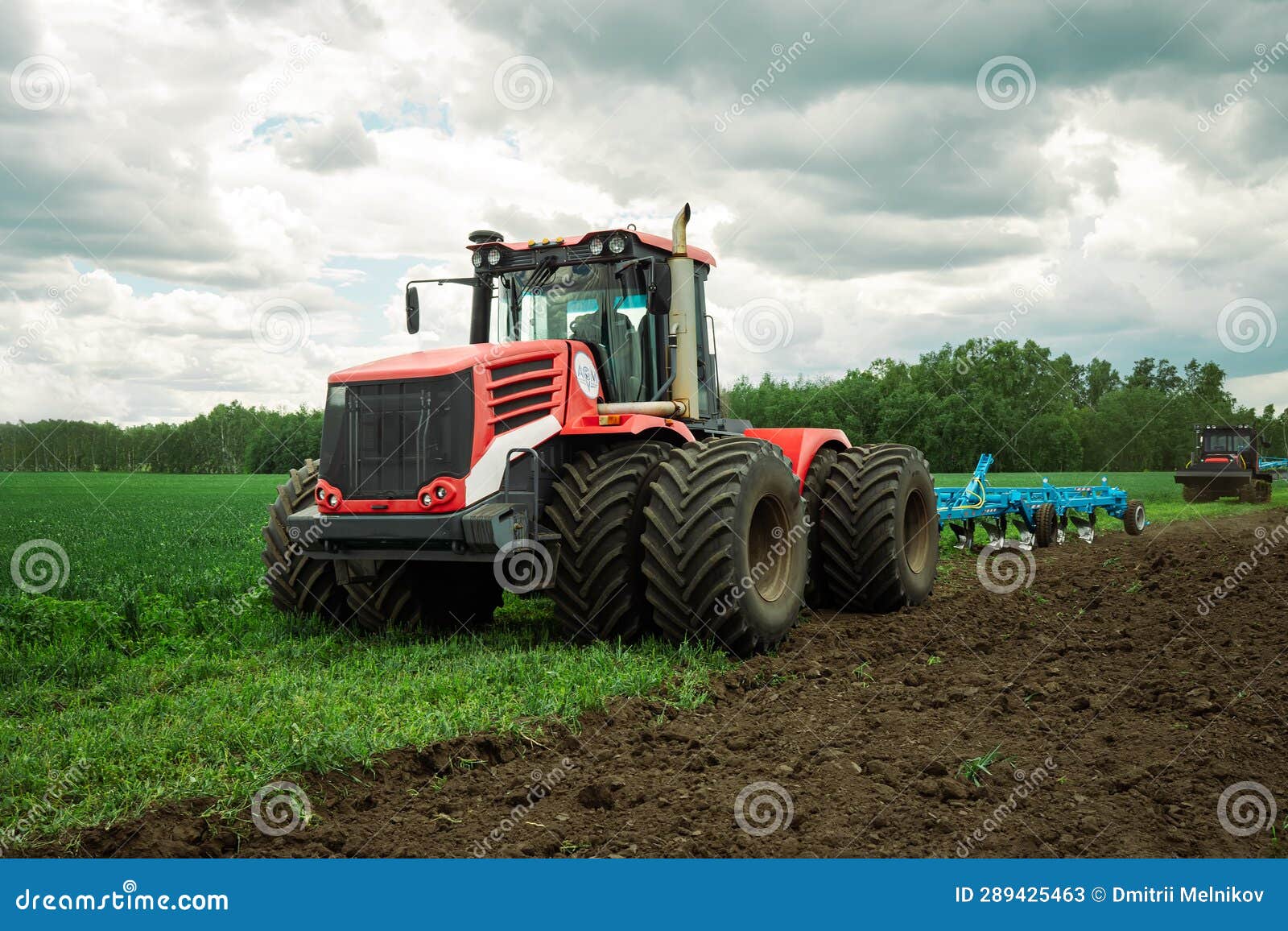 Red Tractor Working in a Field on a Bright Sunny Day. the Concept of ...