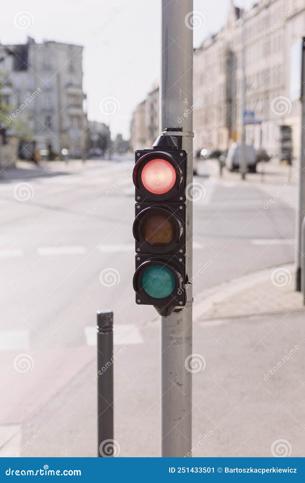 Red Traffic Light on a Blurred Buildings Background Stock Image - Image ...