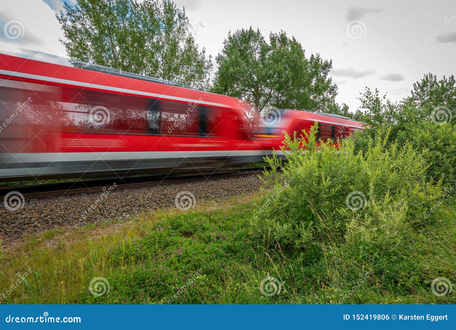Red Train Races Past a Camera Stock Photo - Image of rapid, cobblestone ...