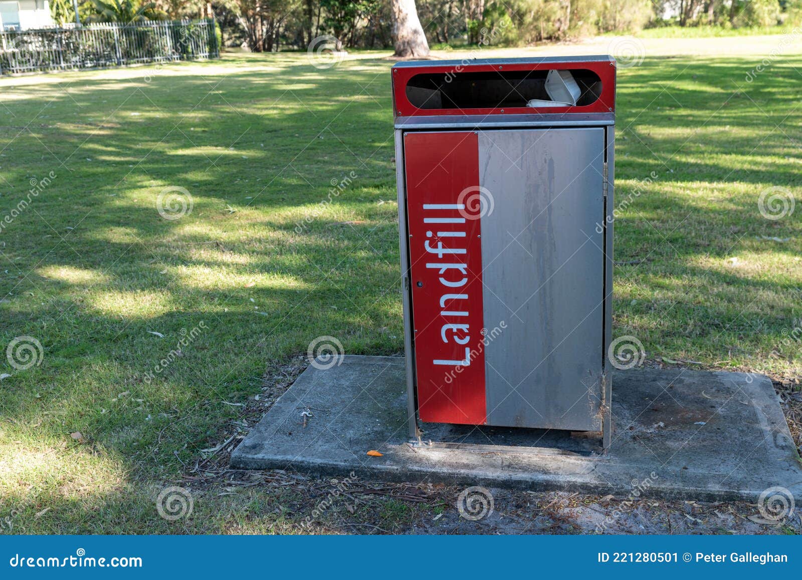 Red Trash Bin with Landfill Sign on it Outside in a Park Stock Image ...