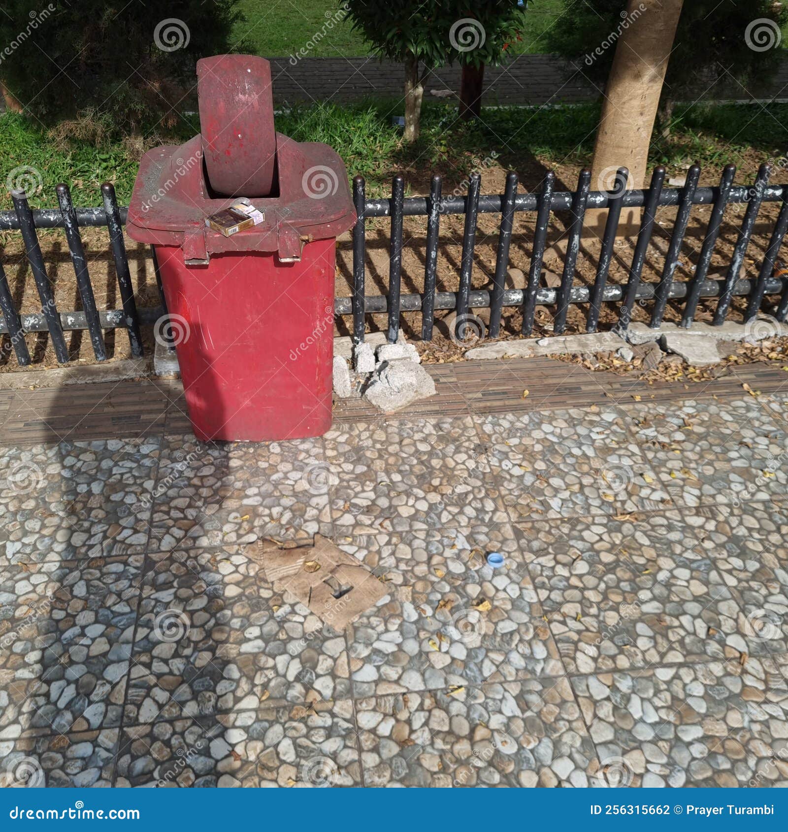 Red trash can in a park stock photo. Image of flooring - 256315662