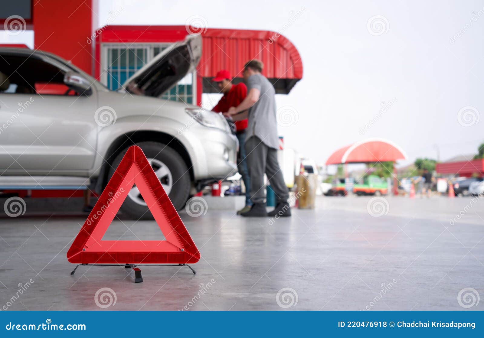 Red Triangle Reflector Roadside Warning on the Floor. There is a Broken ...
