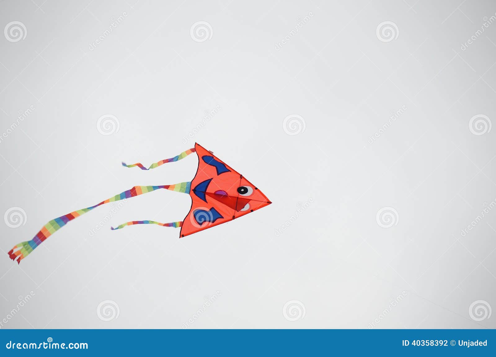 Red Triangular Kite with Multi-color Tails Leaps in a Parabola Stock ...