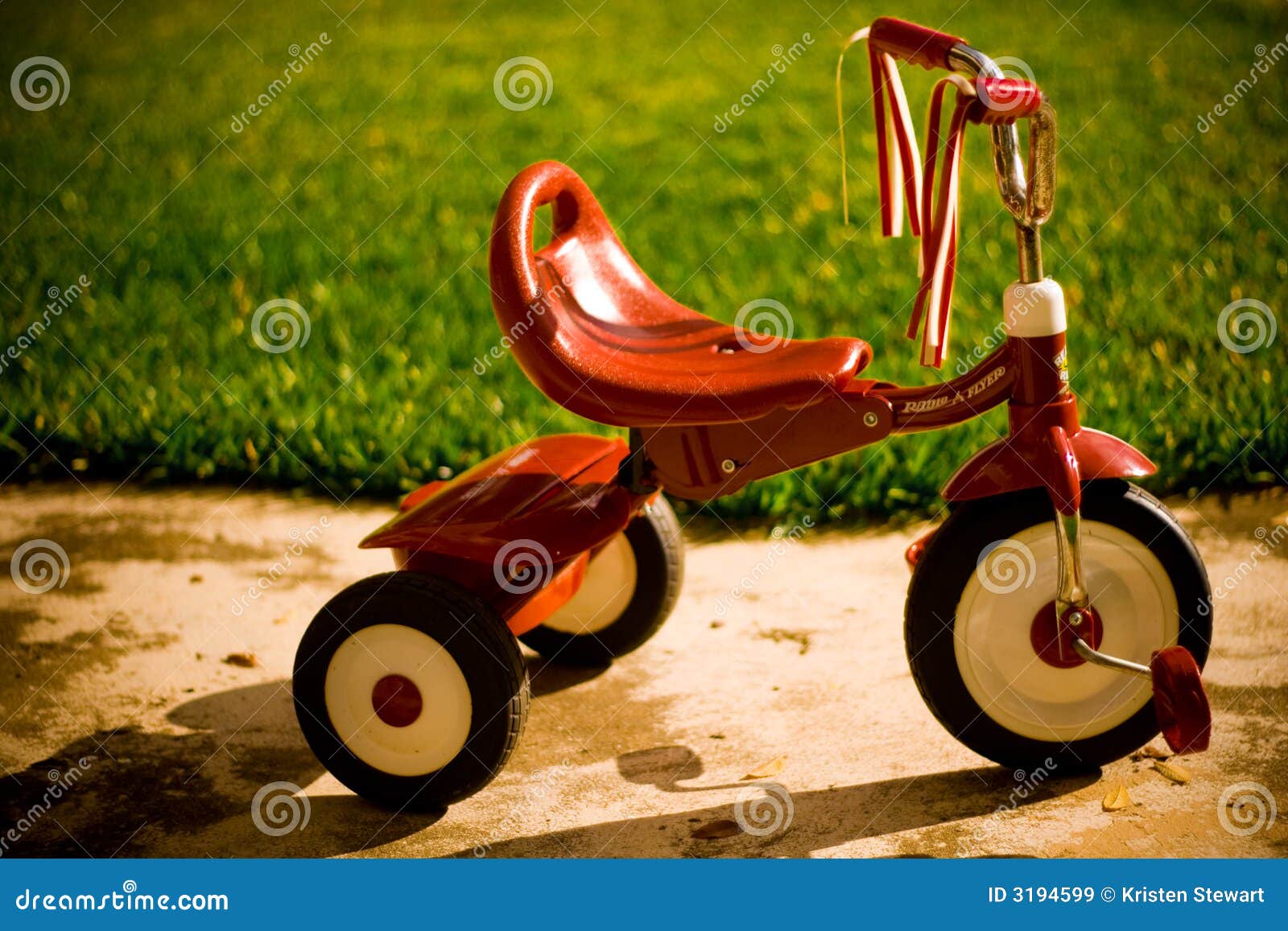 Red Tricycle stock image. Image of streamers, grass, wheel - 3194599