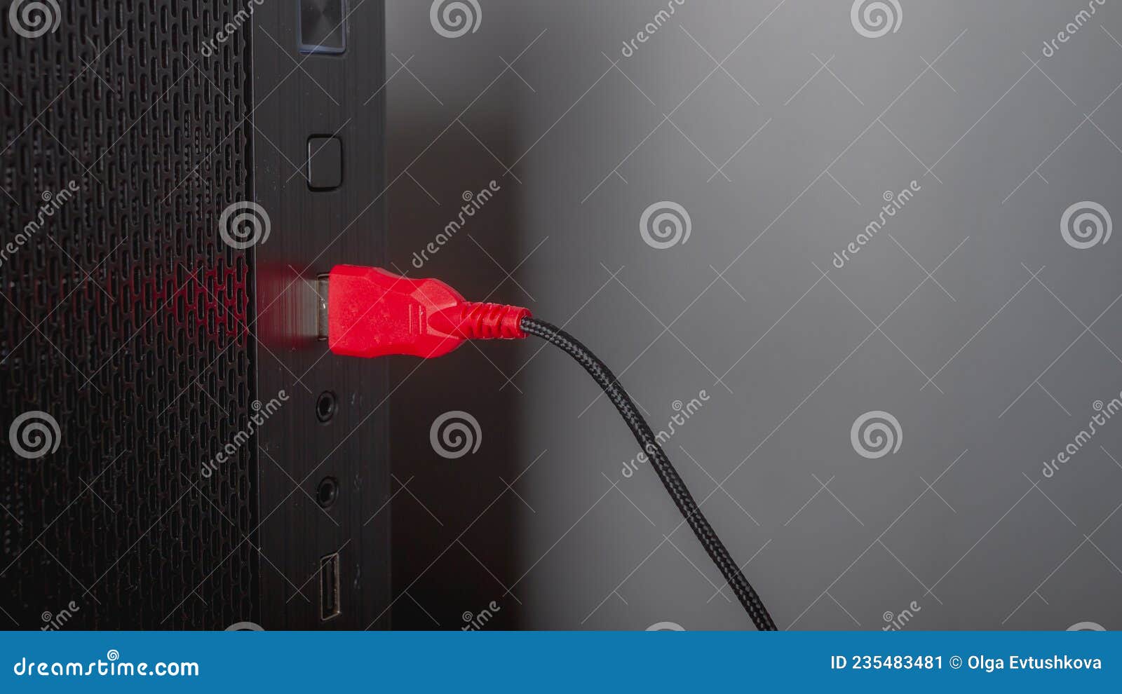 The Red USB Cord is Inserted into the USB Port of the Computer Stock ...