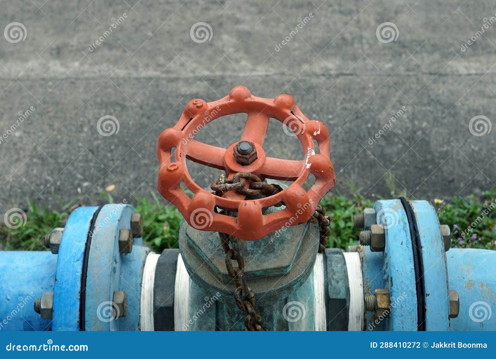 A Red Valve on the Pipe Plumbing beside a Street Stock Photo - Image of ...