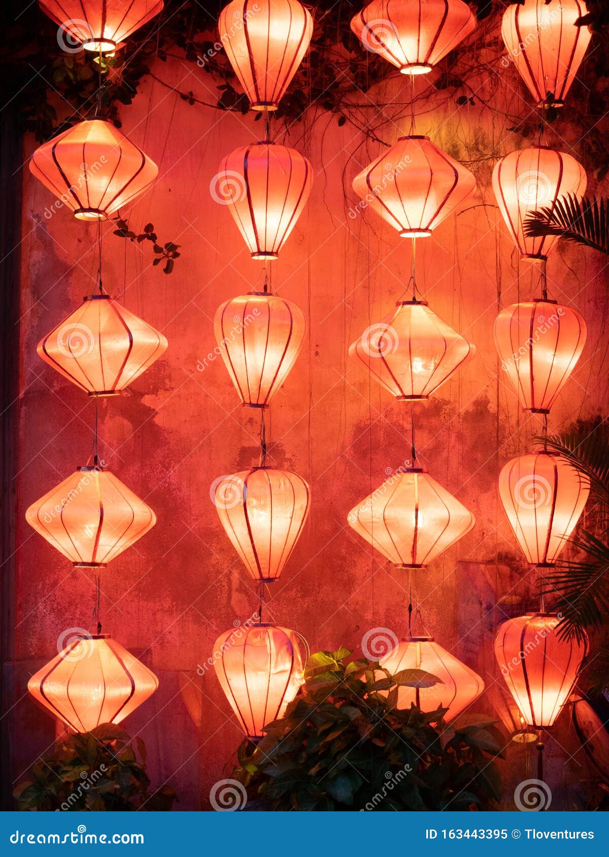 String of Orange Lanterns Against a Red Wall Stock Image - Image of ...