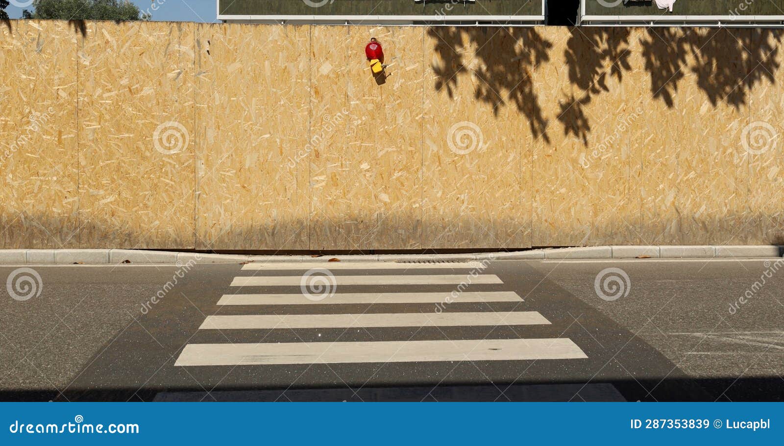 Red Warning Light on Oriented Strand Board Fence at the Roadside during ...
