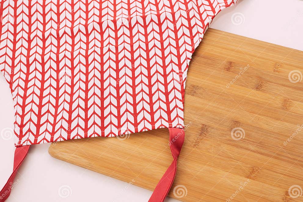 Red White Apron and Cutting Board on a White Table Stock Image - Image ...