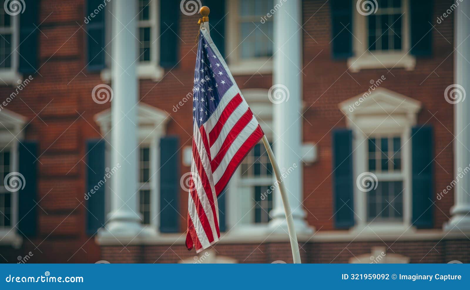 A Red, White, and Blue American Flag is Flying Outside of a Brick Building Stock Photo - Image ...
