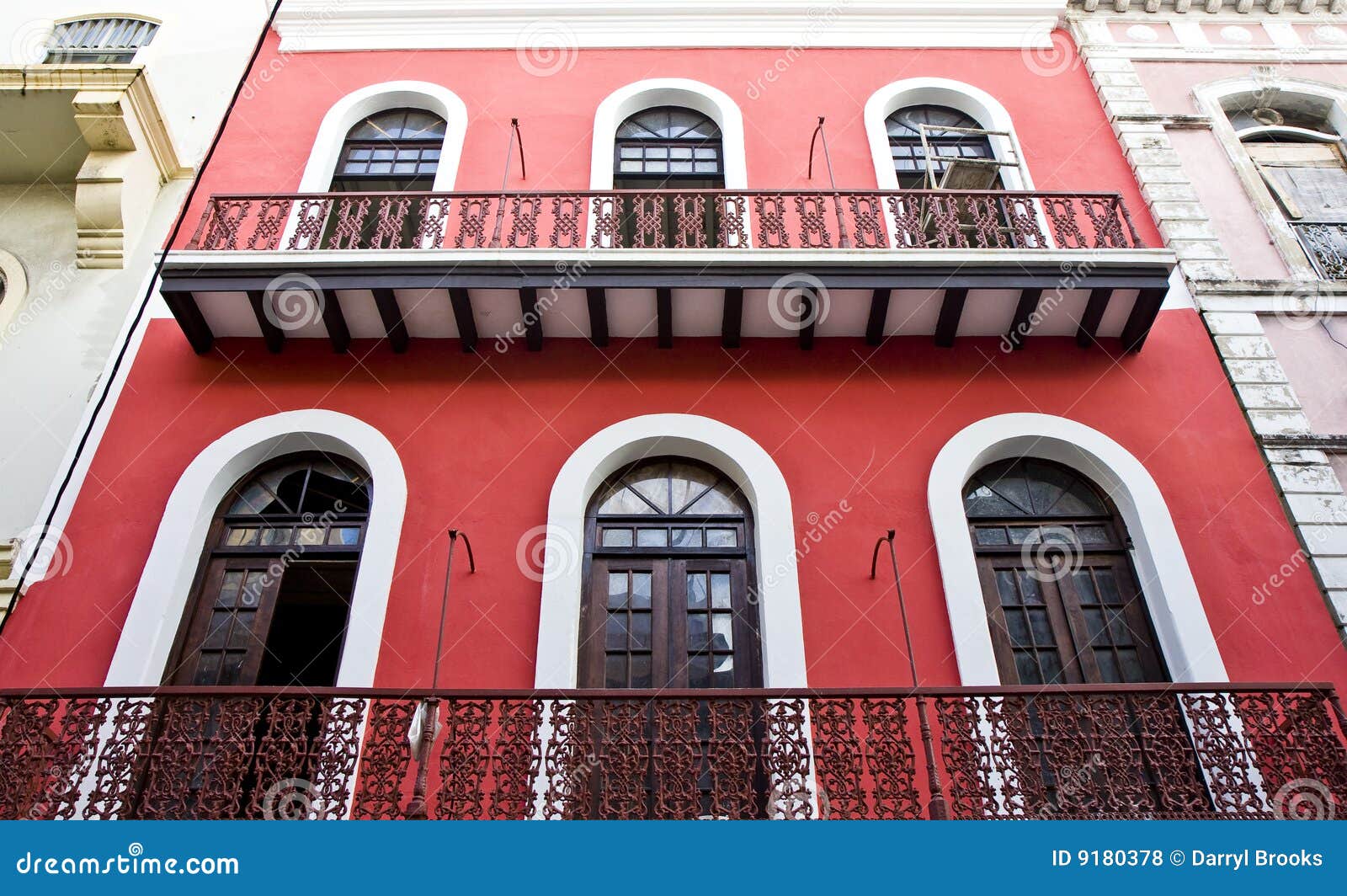 Red and White Building with Red Iron Railing Stock Photo - Image of ...