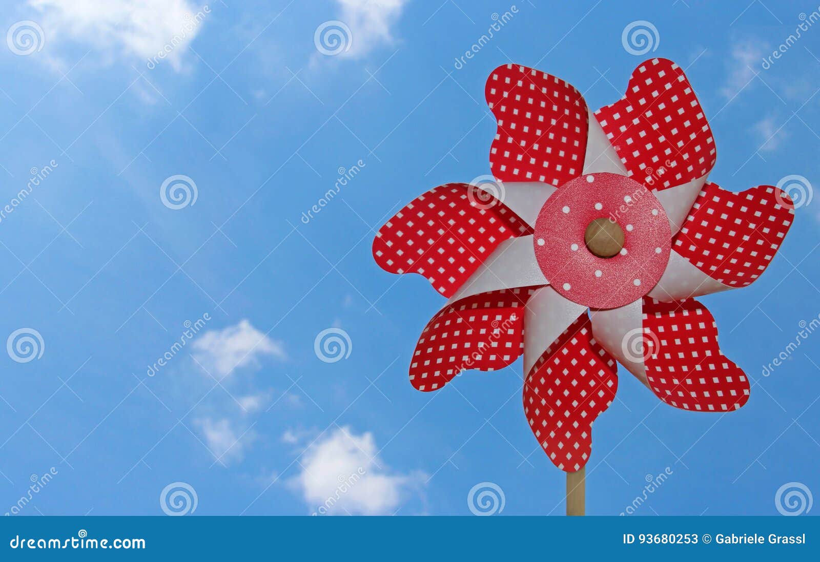 Red and White Pinwheel Against Blue Sky Stock Image - Image of people ...