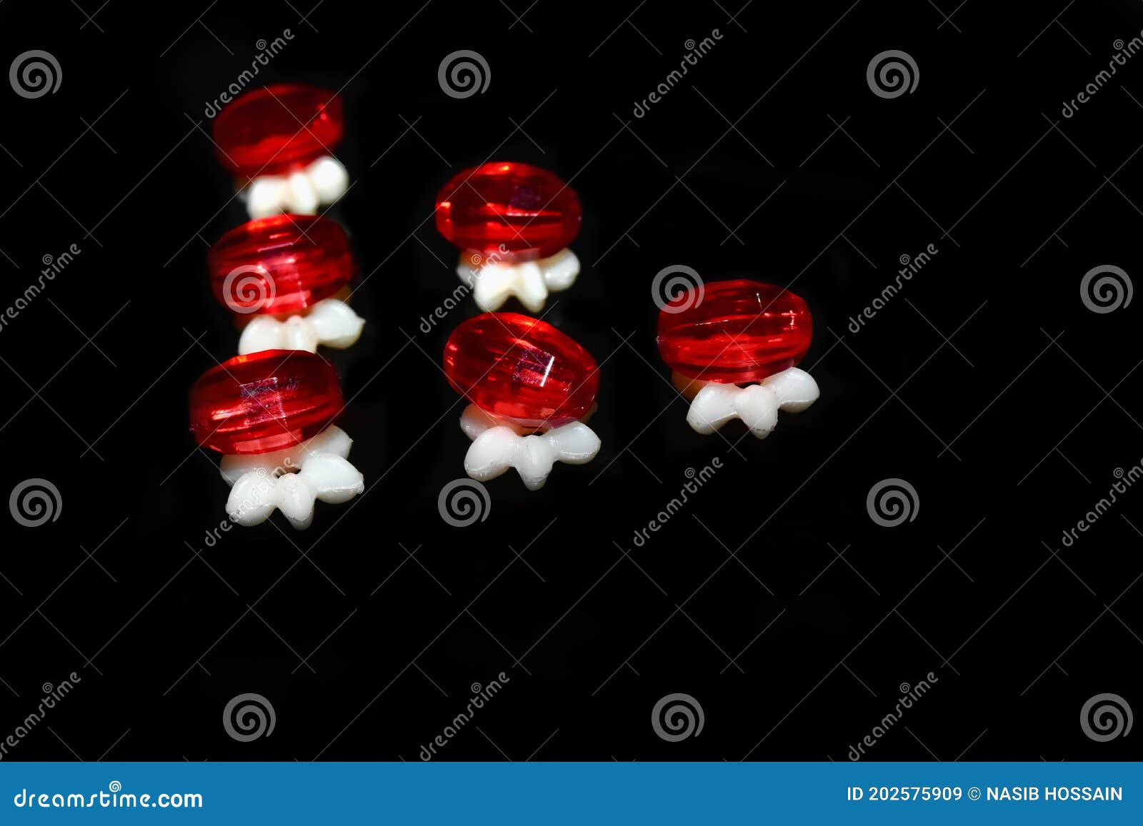 Red and White Plastic Small Objects on Black Surface Stock Image ...