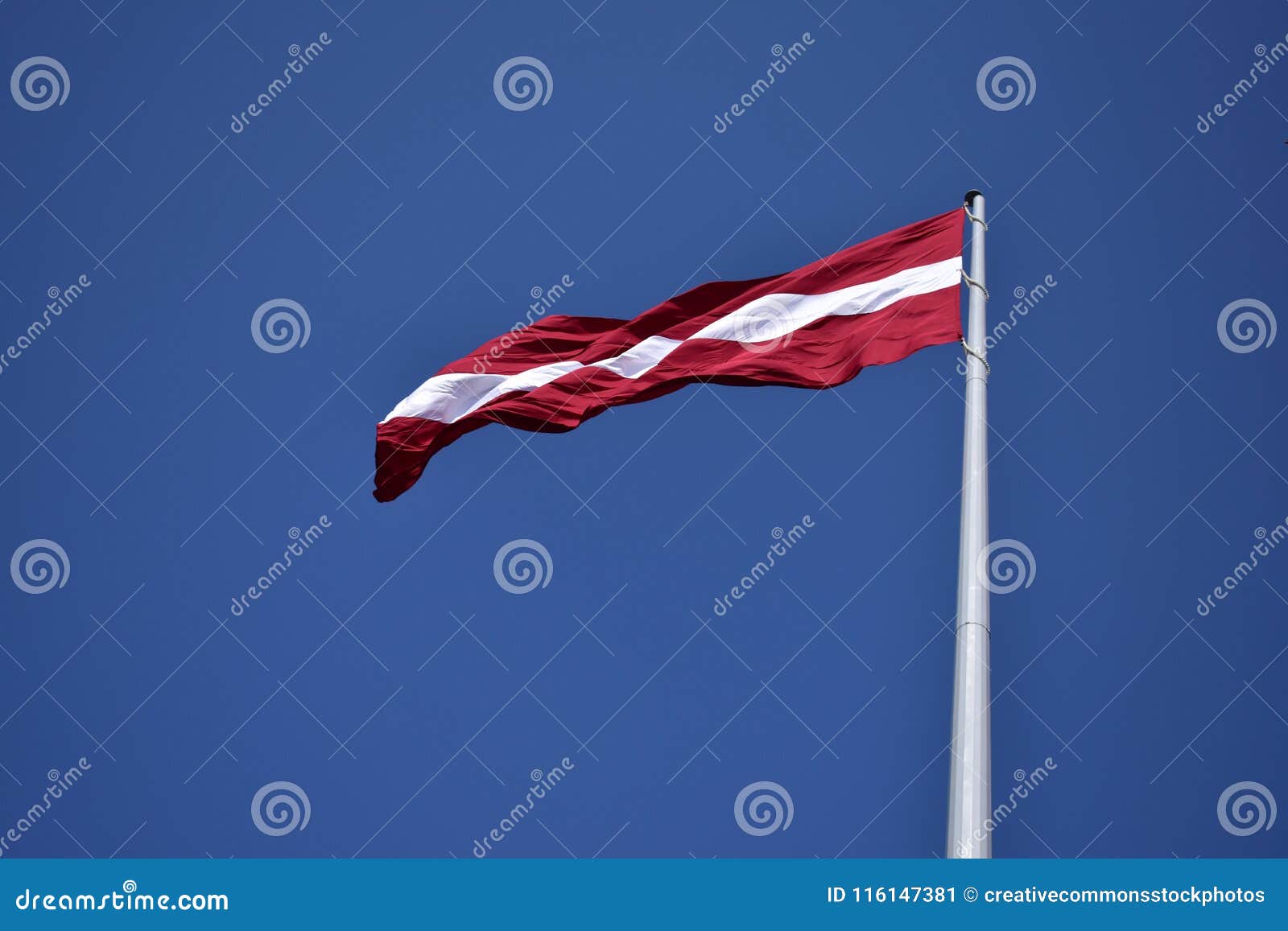 Red And White State Flag Waving Under Blue Sky At Daytime Picture ...