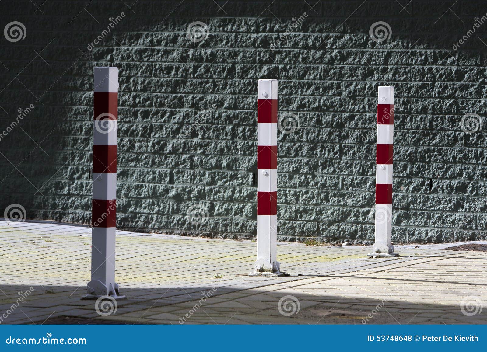 Red and White Striped Poles Stock Photo - Image of pavement, sign: 53748648