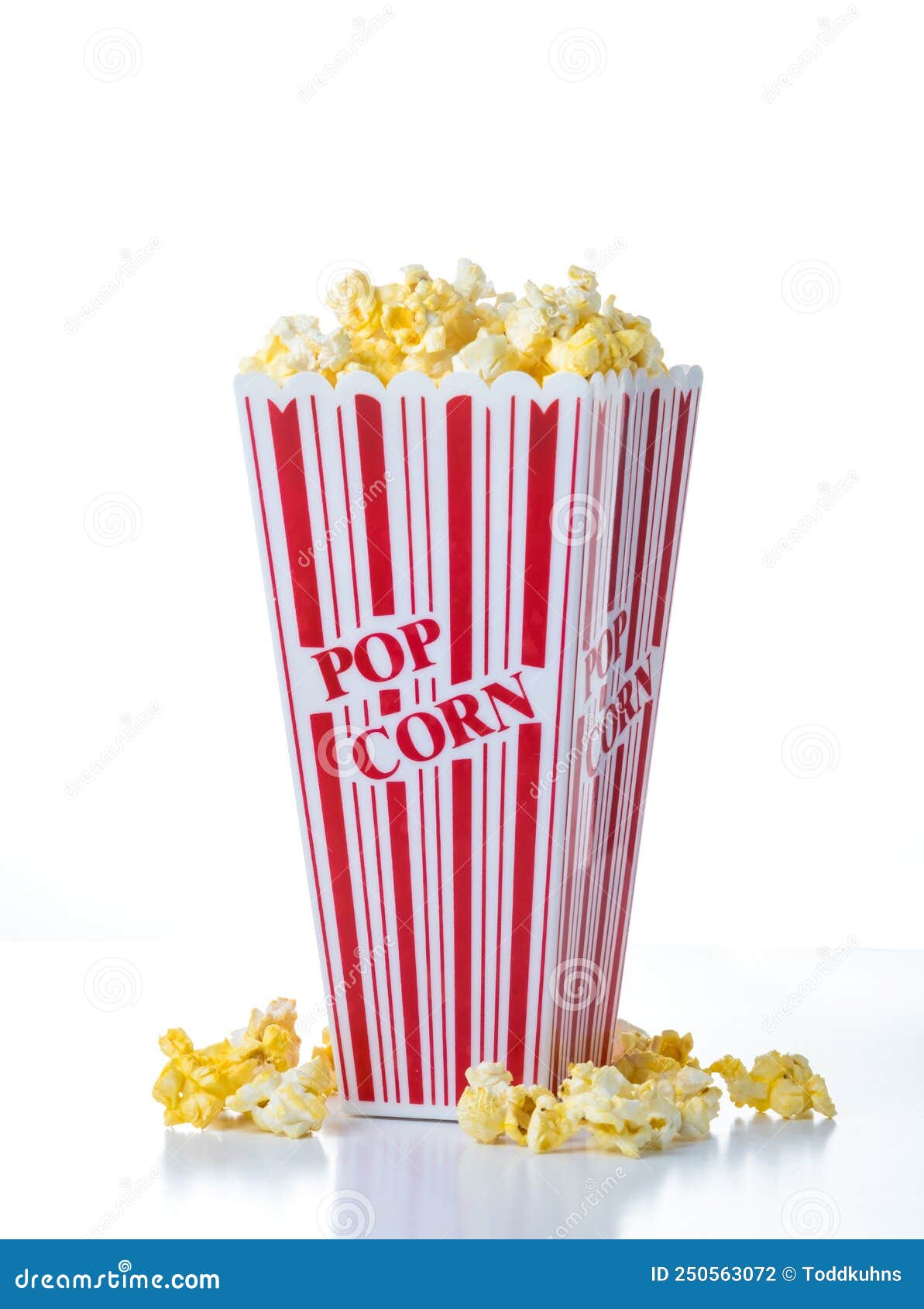 Red and White Striped Popcorn Container with Popcorn on a White ...