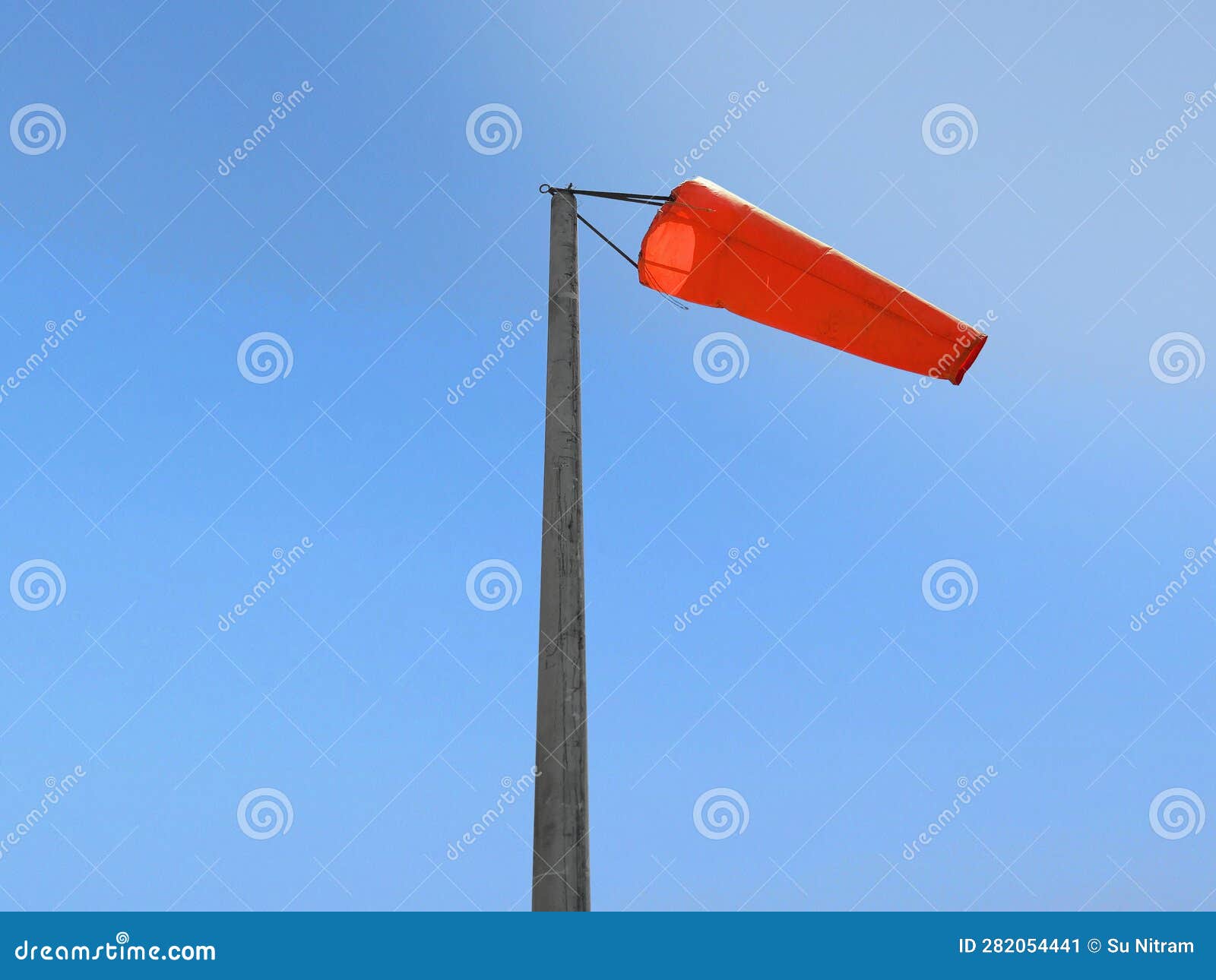 Red Windsock, Wind Sleeve Flying on a Blue Sky. Wind Force and ...