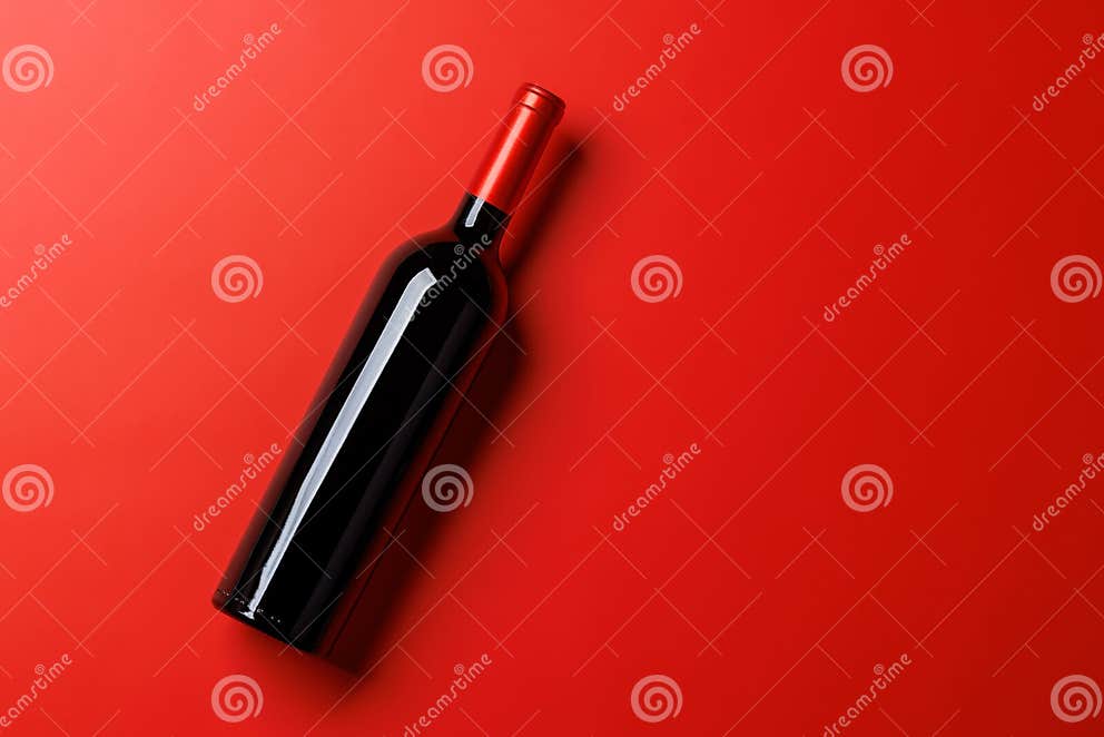 A Red Wine Bottle Lying Horizontally on a Bold Red Background Stock ...