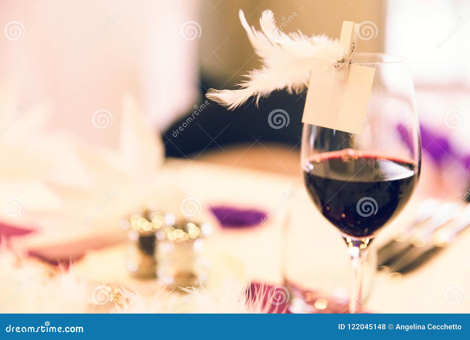 Red Wine Glass Feather Name Tag on Wedding Table Stock Photo - Image of ...