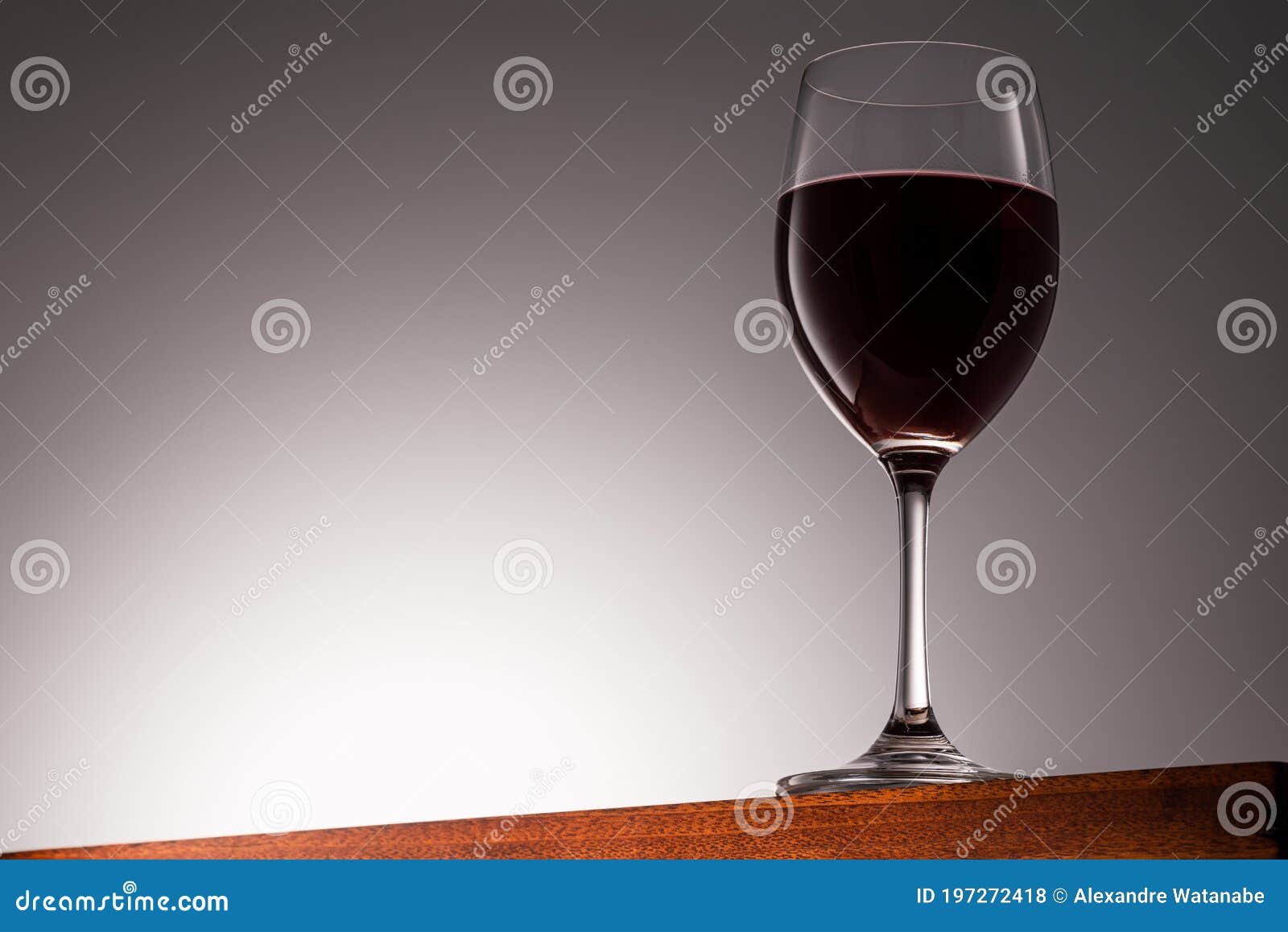Red Wine in a Glass on a Wooden Surface and Gradient Background Stock ...