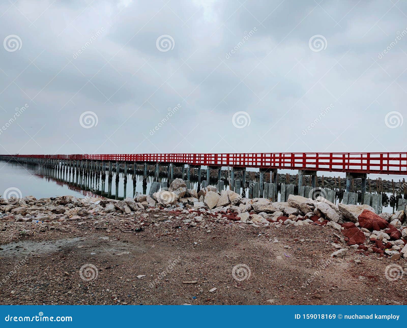 The Red Wooden Bridge Made a Walkway Extending into the Sea. Stock ...