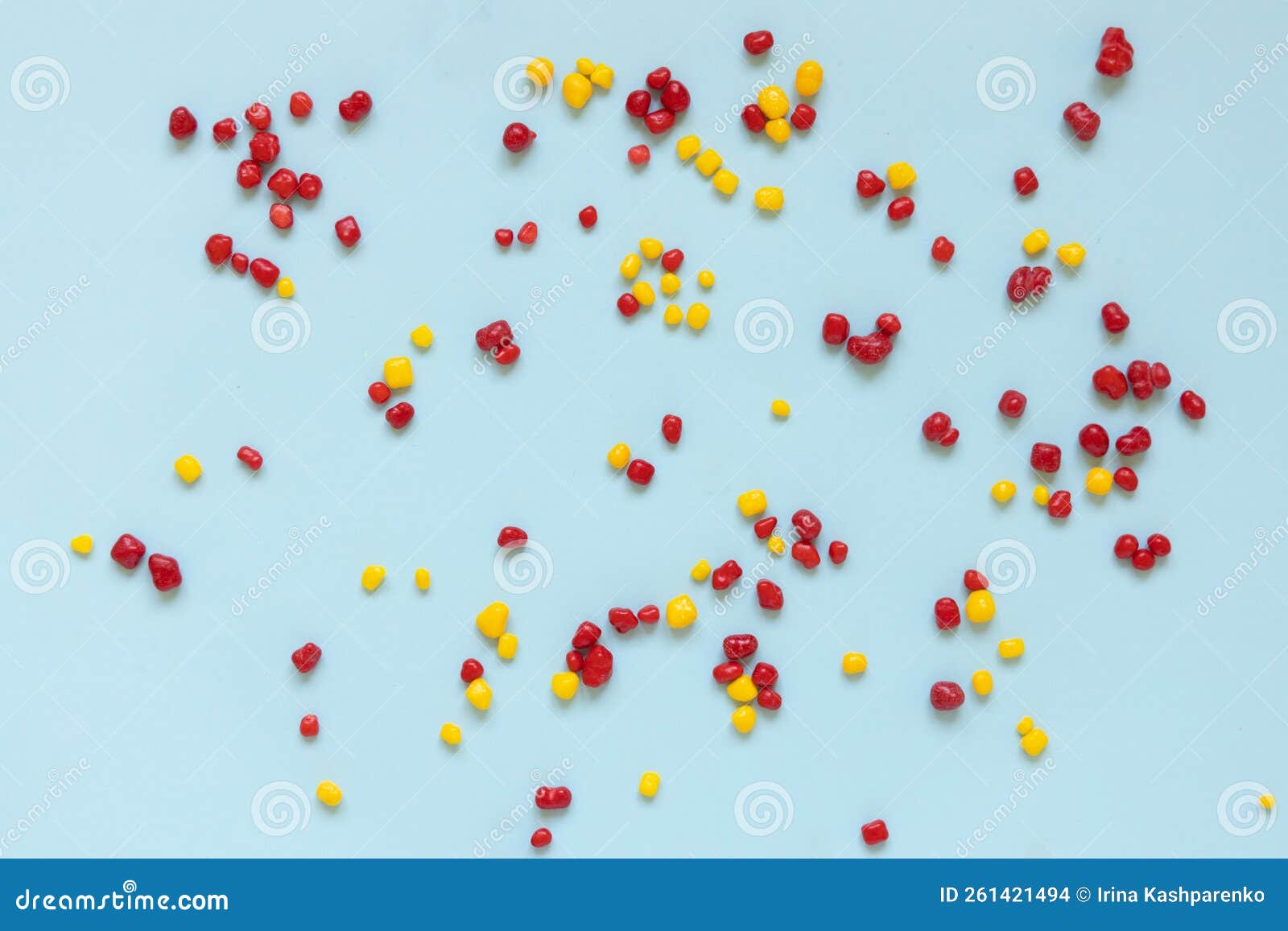 Red and Yellow Colored Candy Nerds Sprinkled on a Blue Background ...