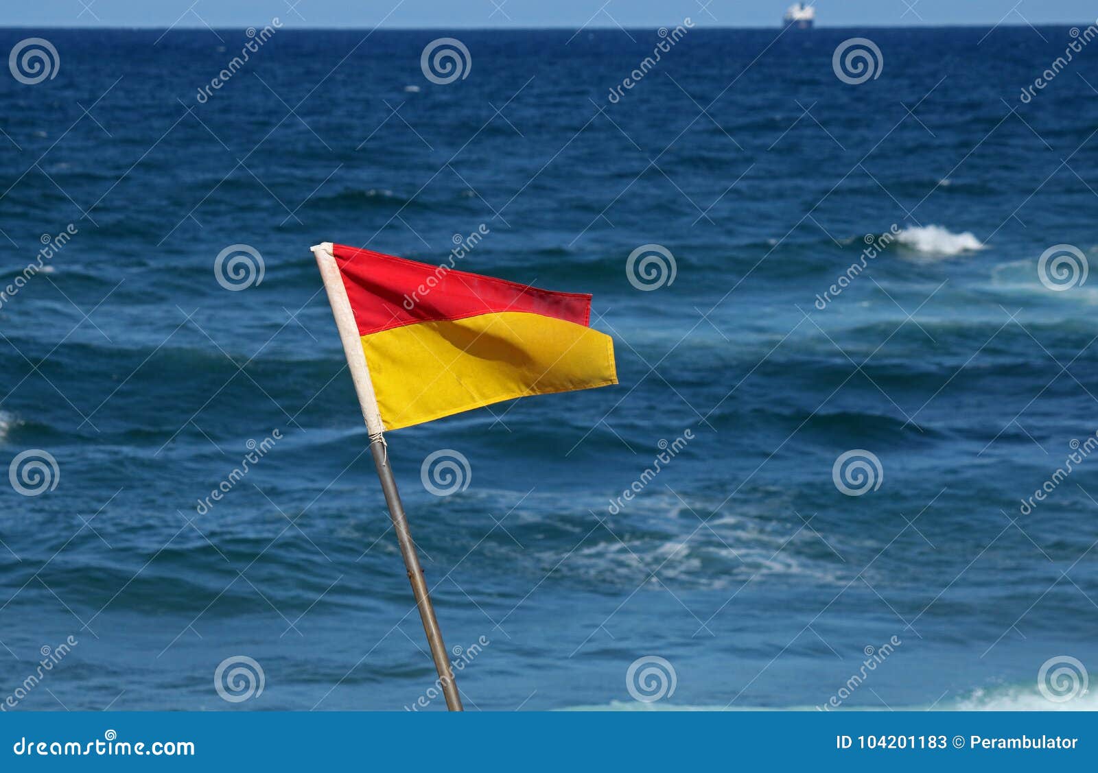 RED and YELLOW LIFEGUARD FLAG with SEA in BACKGROUND Stock Image ...