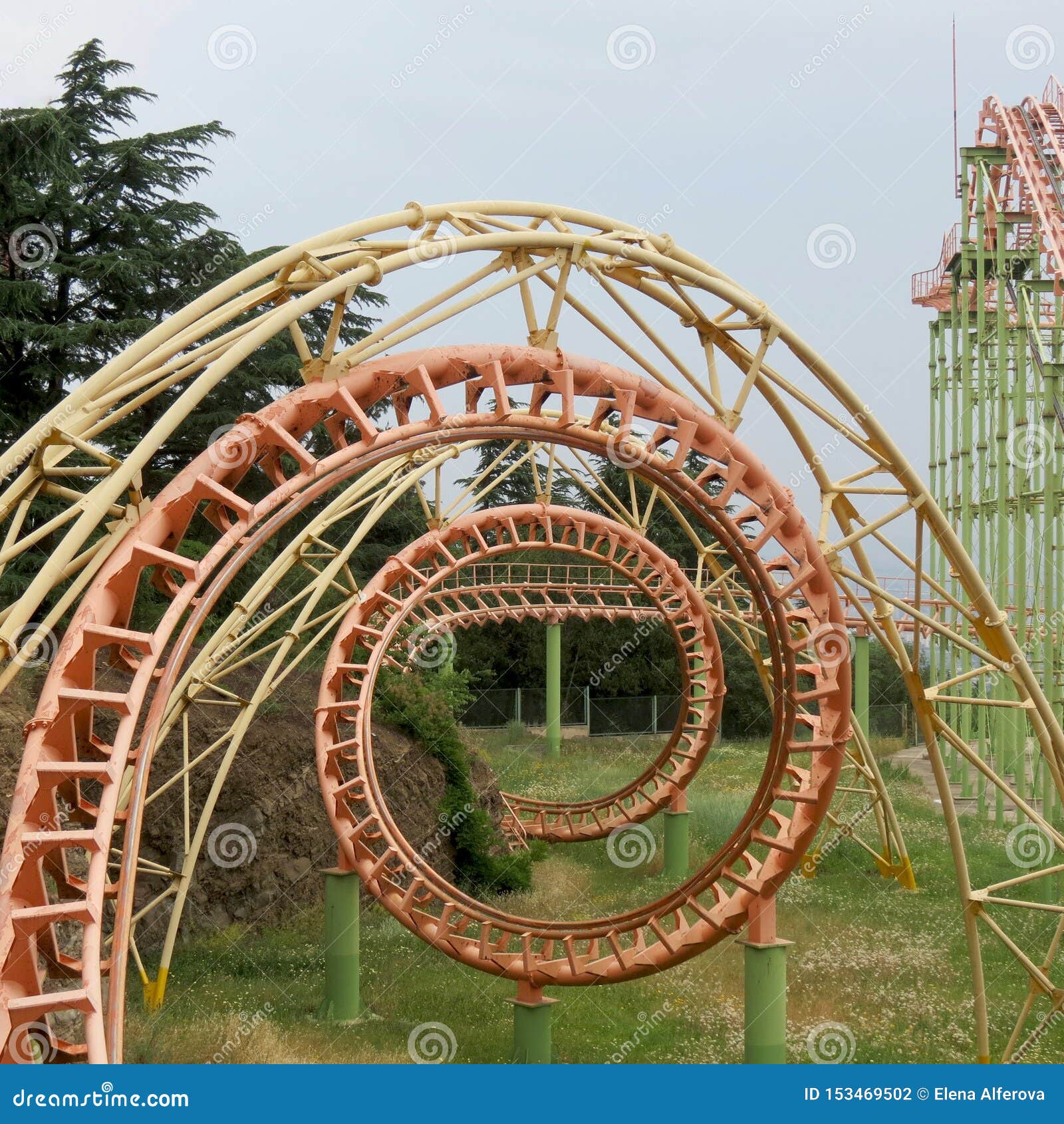 The Loops of an Old Unworking Roller Coaster on Blue Sky Background ...
