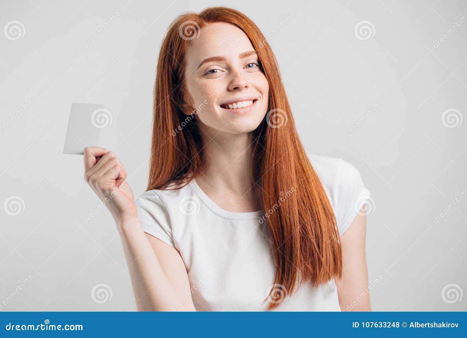 Redhead Girl Holding Credit Card and Smiling on White Background. Stock ... Redhead Girl Holding Credit Card and Smiling on White Background. Stock ...