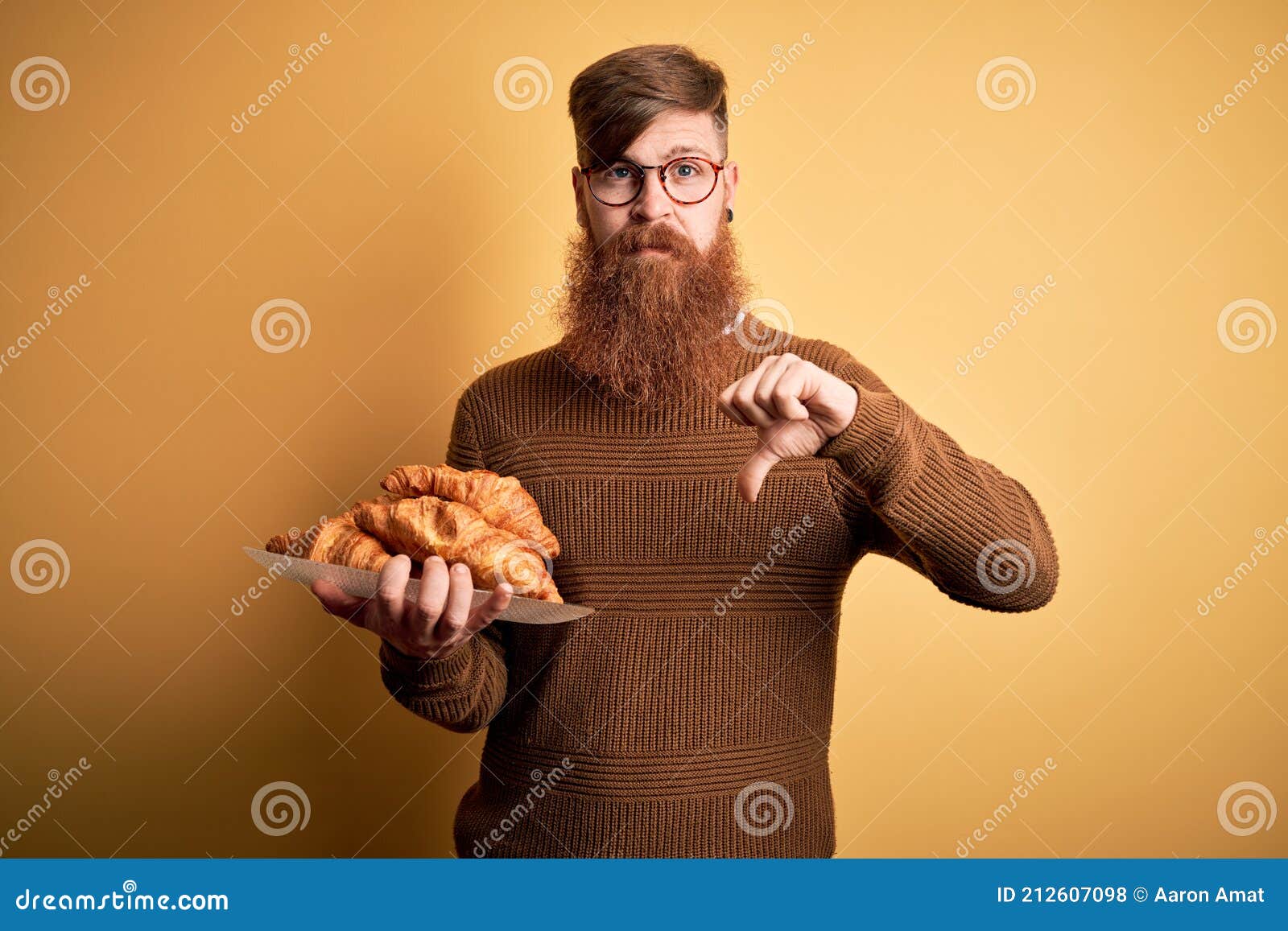 Redhead Irish Man With Beard Doing Housework Laundry Over Yellow Background With Angry Face